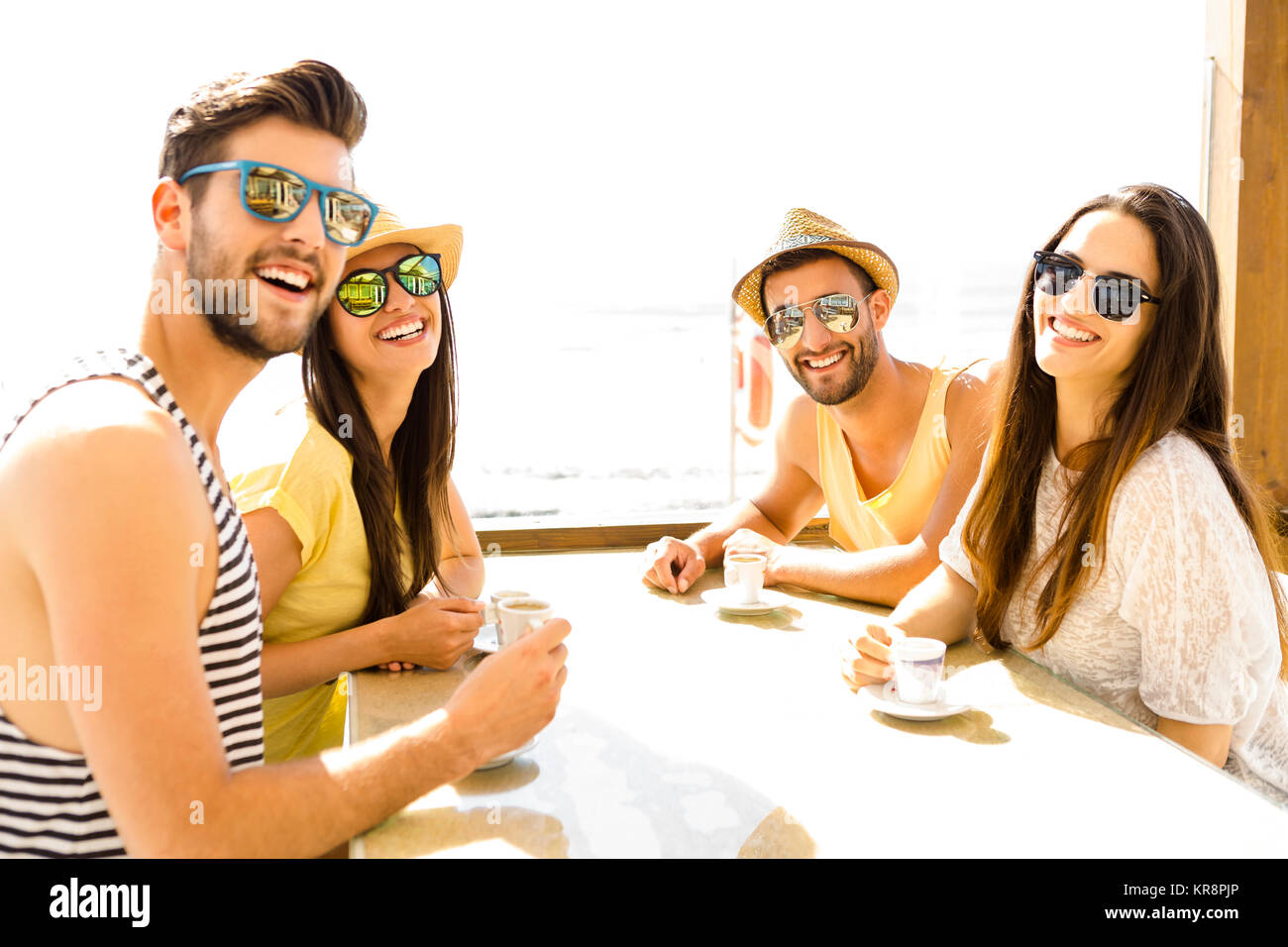 Friends at the beach bar Stock Photo - Alamy