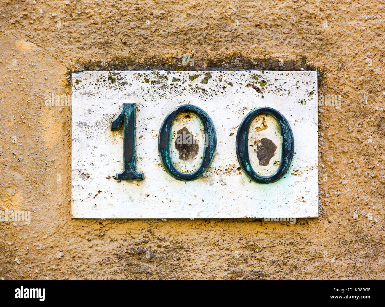 House number 100 on wall Stock Photo - Alamy