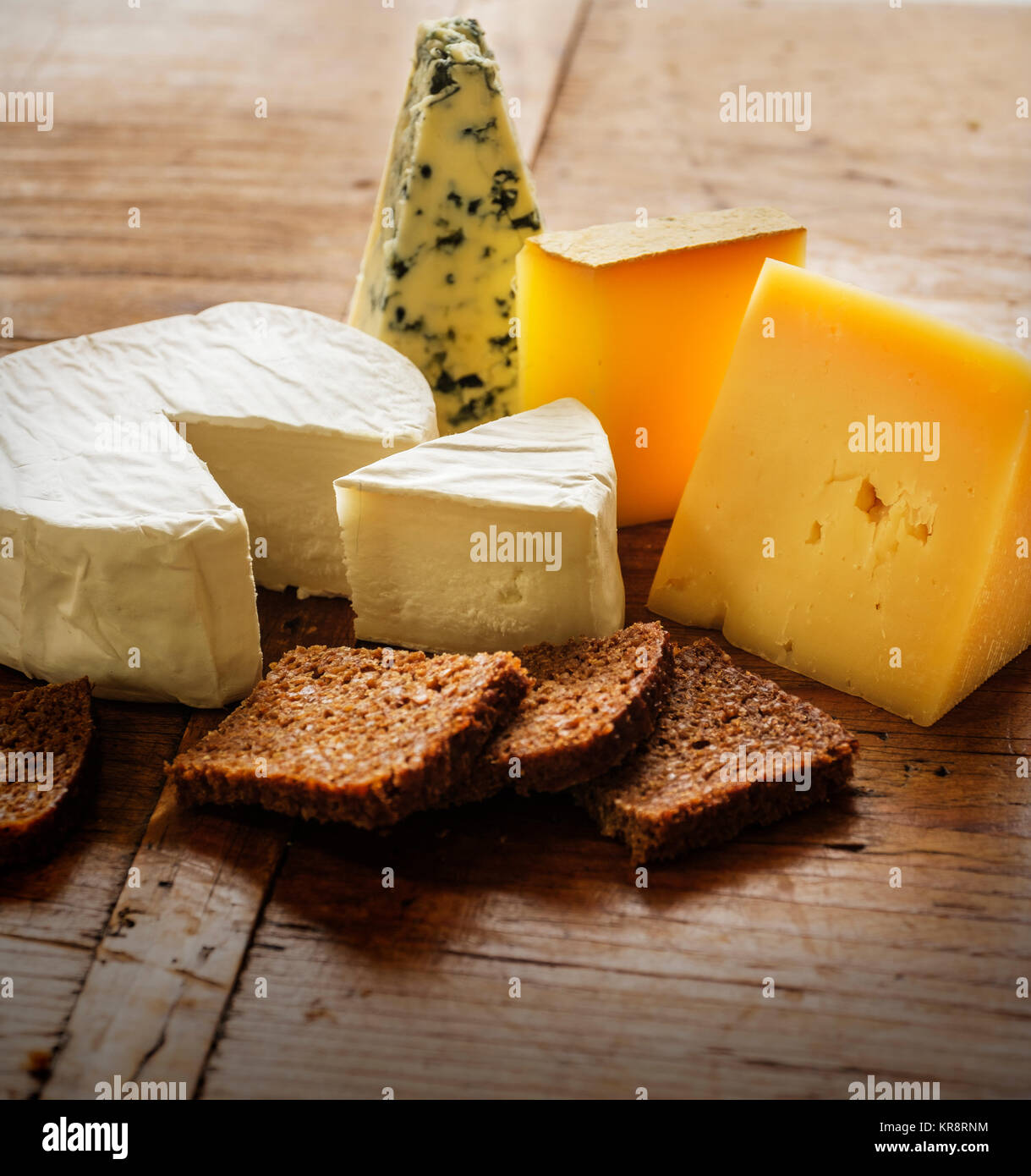 Assorted cheeses and bread slices Stock Photo - Alamy