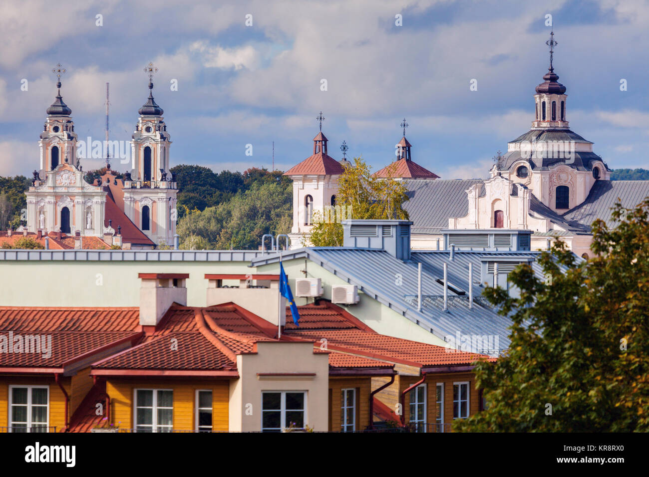 Lithuania, Vilnius, Residential building with churches in background ...