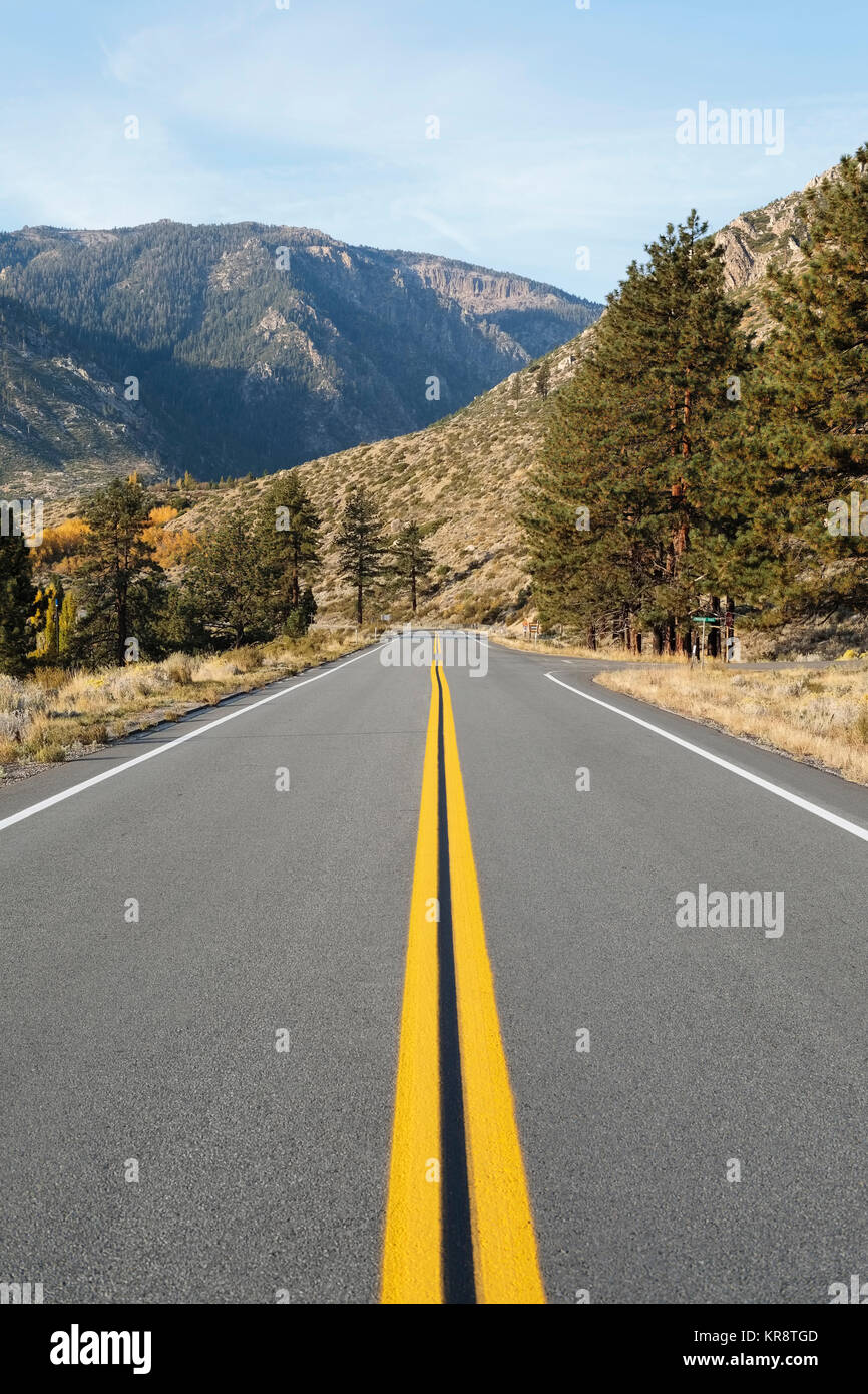 USA, California, Eastern Sierras, Route 88, Empty road with mountain in ...