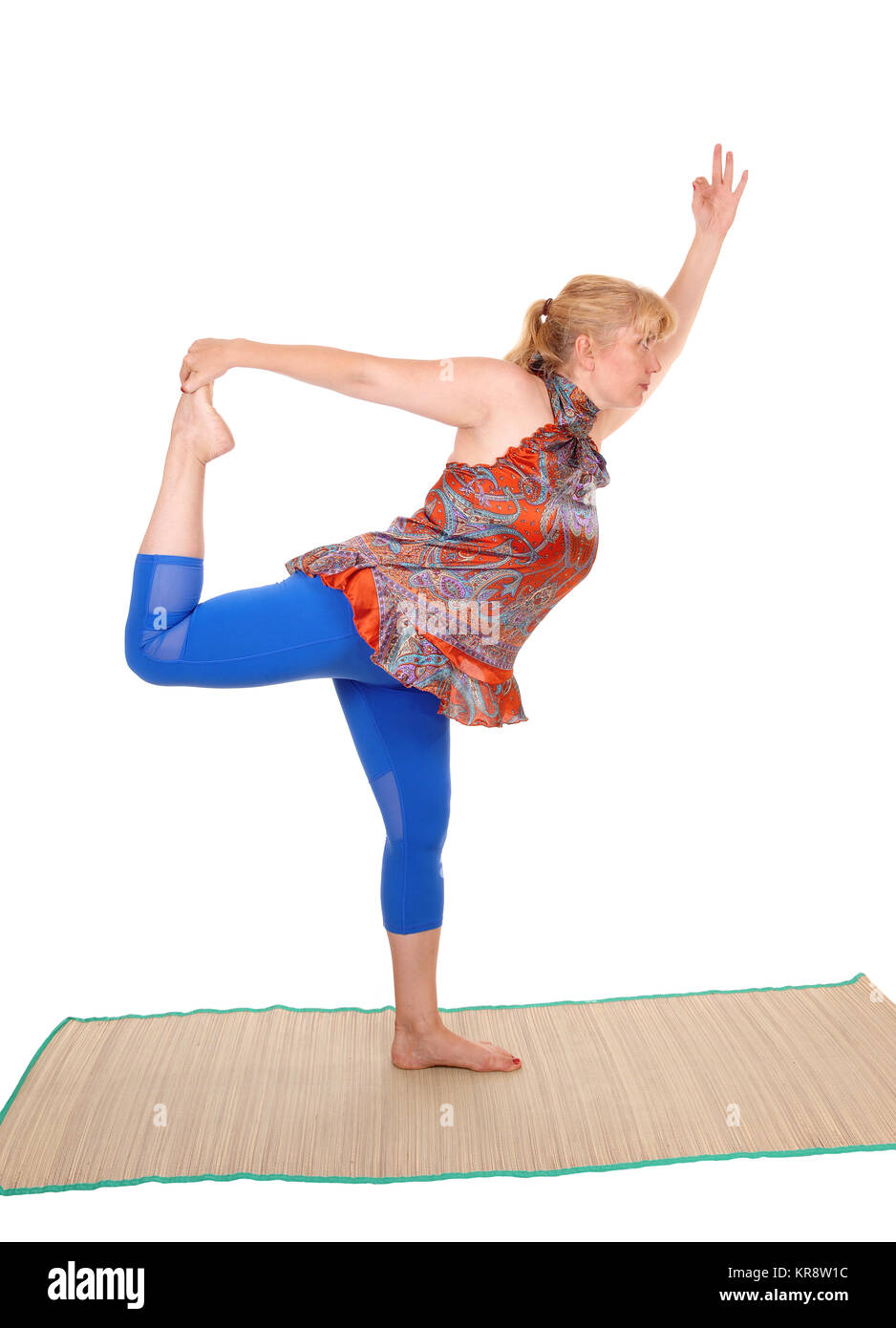 Yoga trainer standing on one leg Stock Photo - Alamy
