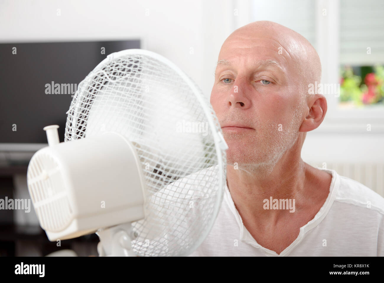 mature man refreshed with a fan Stock Photo - Alamy