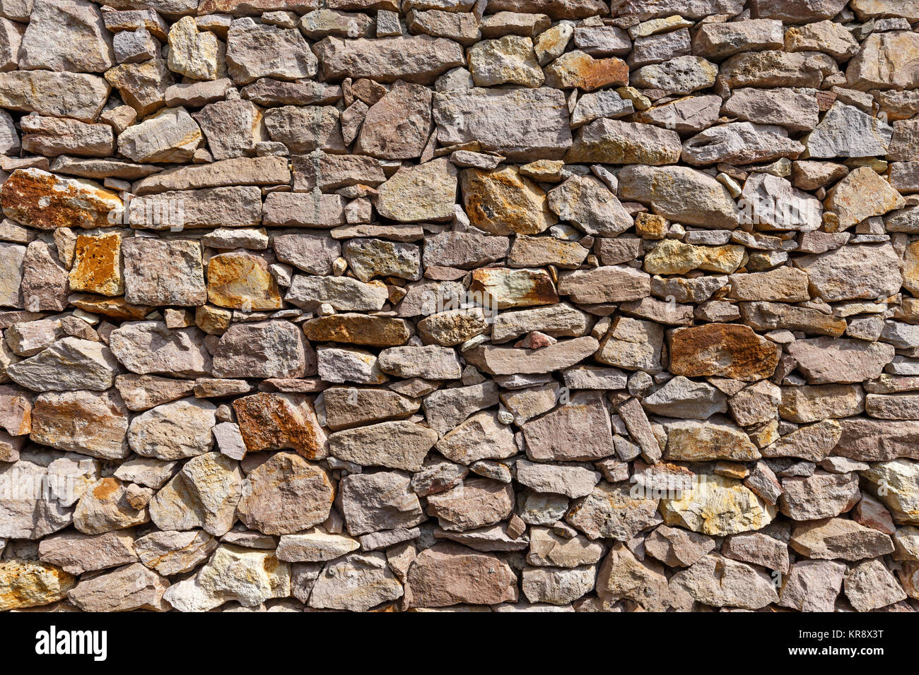 Uneven cracked real stone wall Stock Photo - Alamy