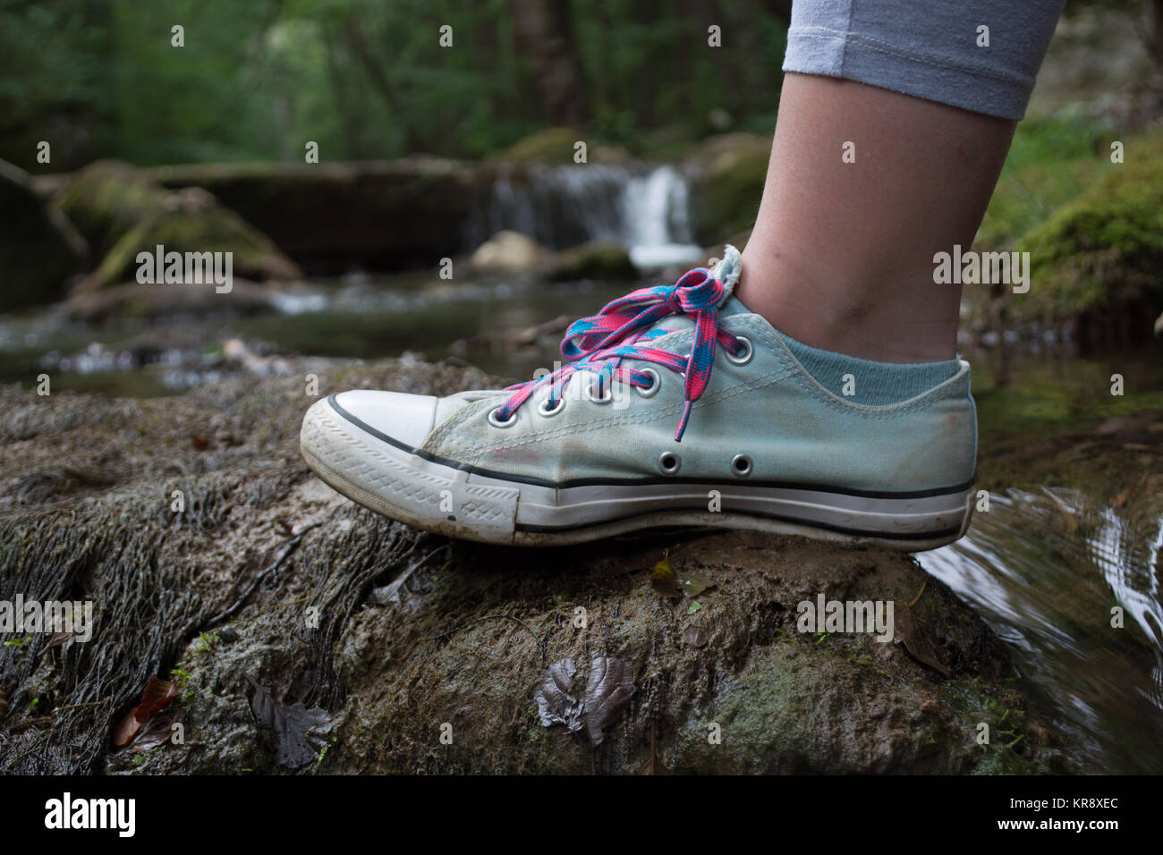 Girls foot stepping on a mossy rock Stock Photo - Alamy