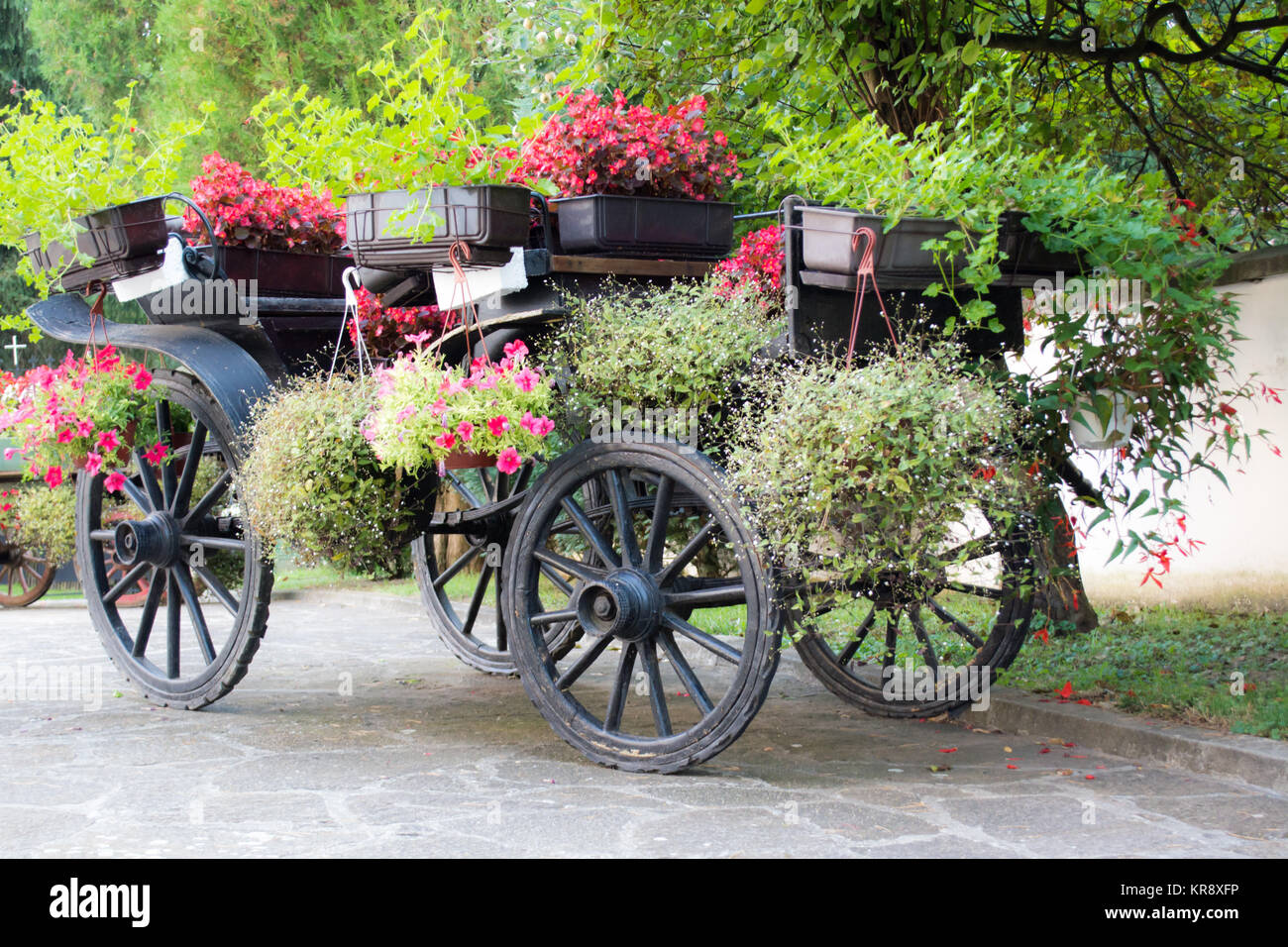 Old rustic wooden rural carriage with summer flowers in it Stock Photo ...