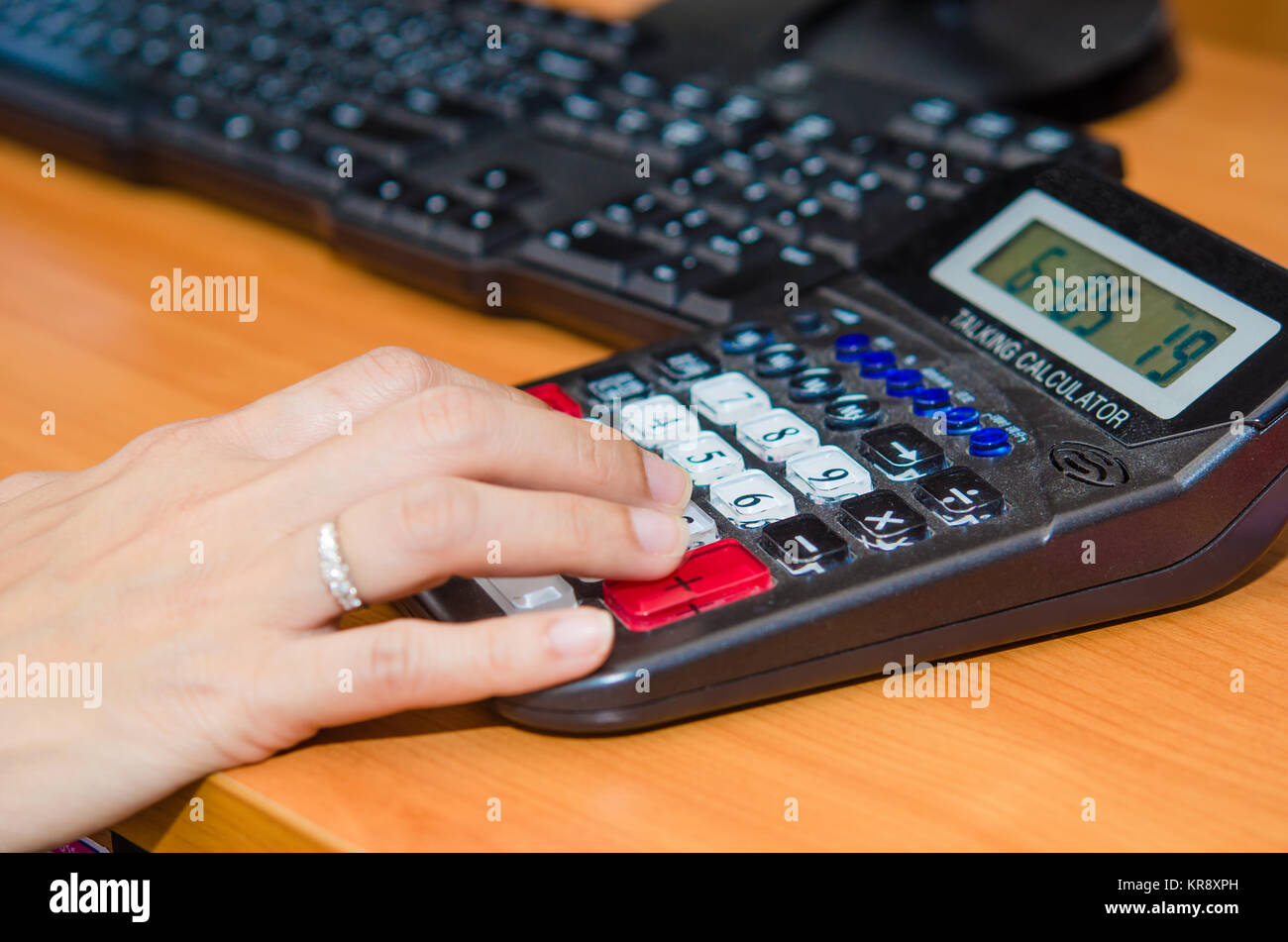 Hand and calculator Stock Photo - Alamy
