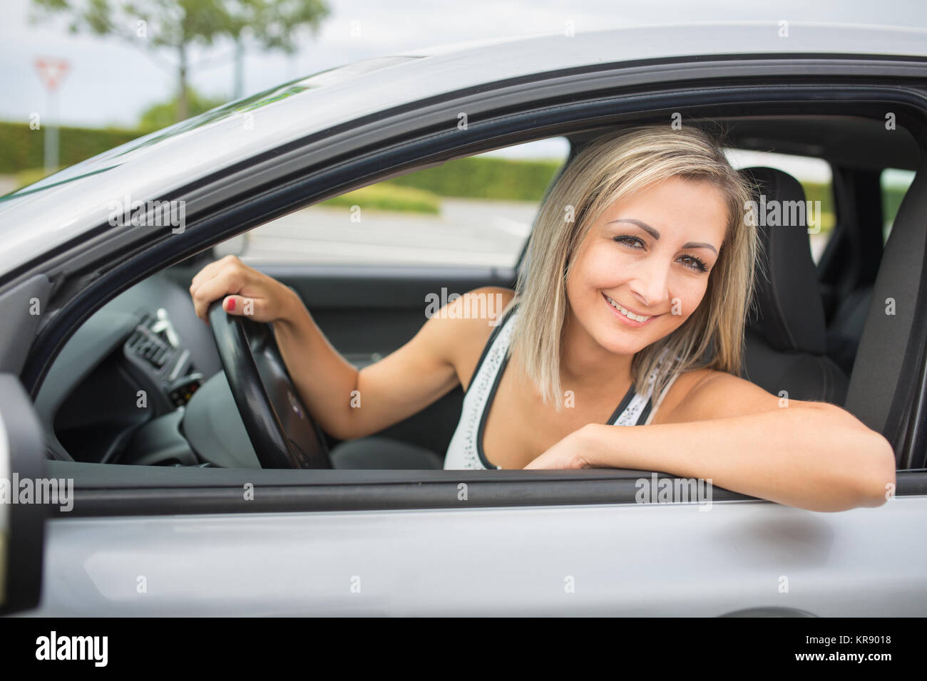 Woman driving a car - female driver at a wheel of a modern car, looking ...