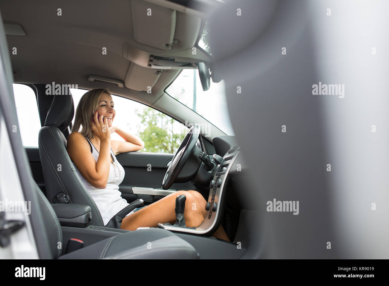 Woman driving a car - female driver at a wheel of a modern car, looking ...