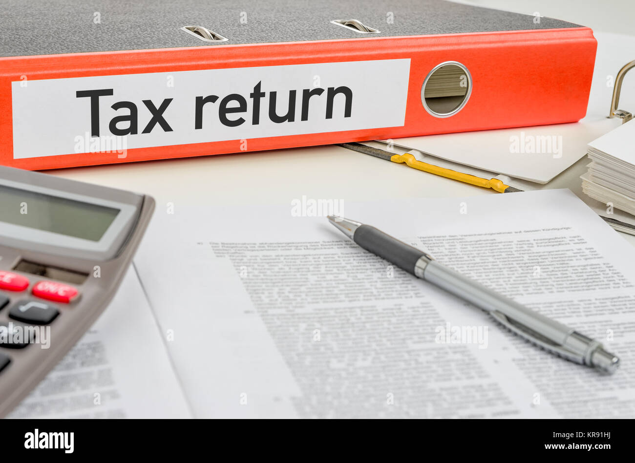 An orange folder with the label Tax return Stock Photo - Alamy