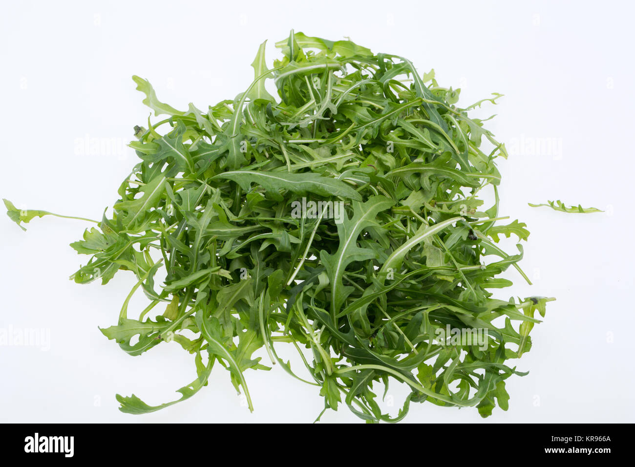 Heap of ruccola leaves isolated on white background Stock Photo - Alamy
