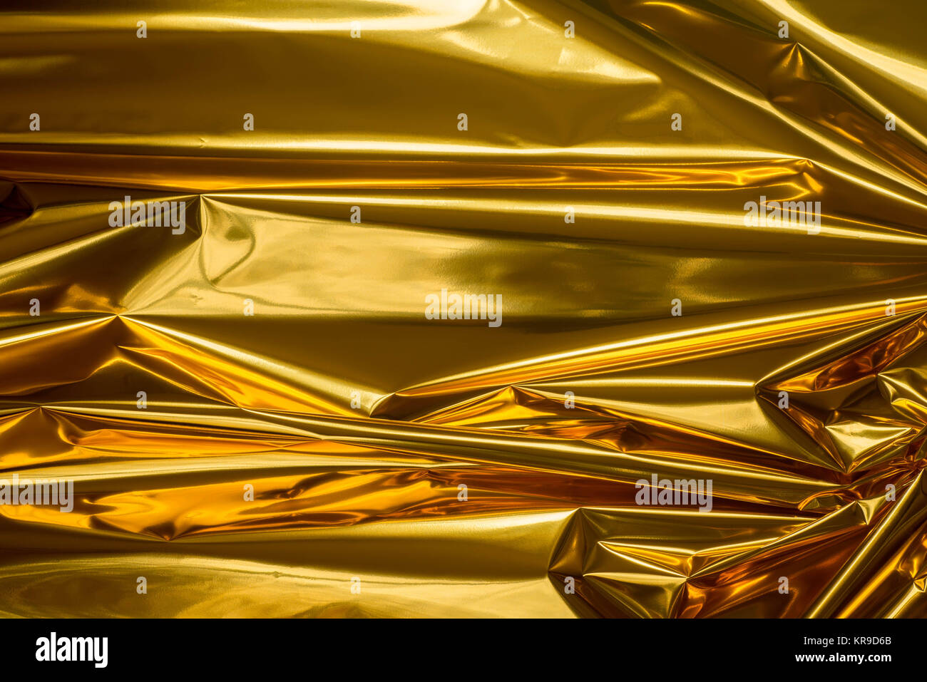 golden color folded metallic foil abstract bacgkground Stock Photo - Alamy