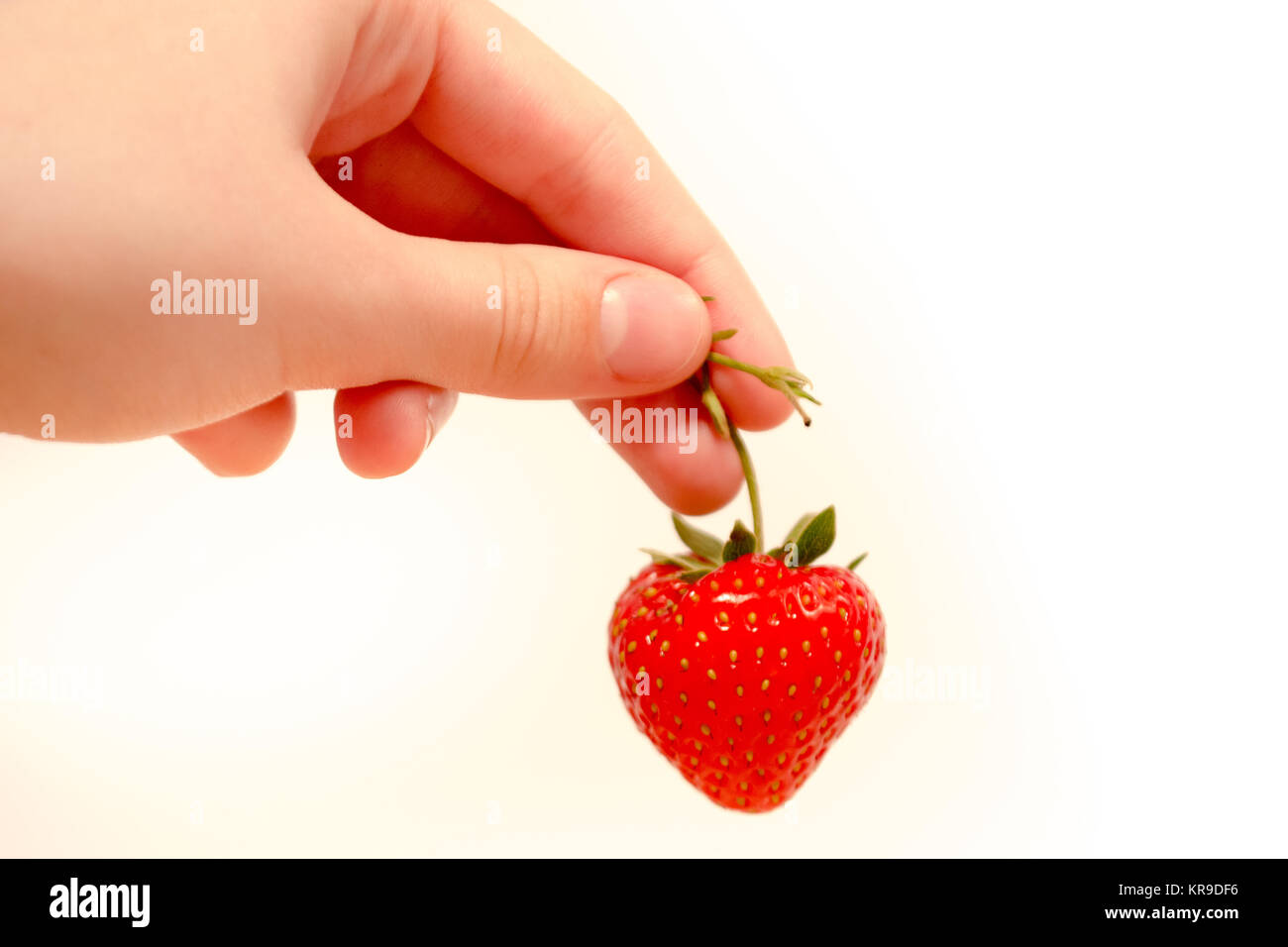 Hand with strawberry Stock Photo - Alamy