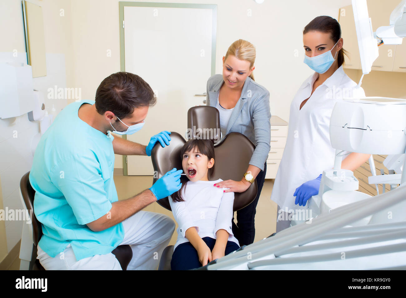Little girl with her mother at the Dentist before treatment Stock Photo ...