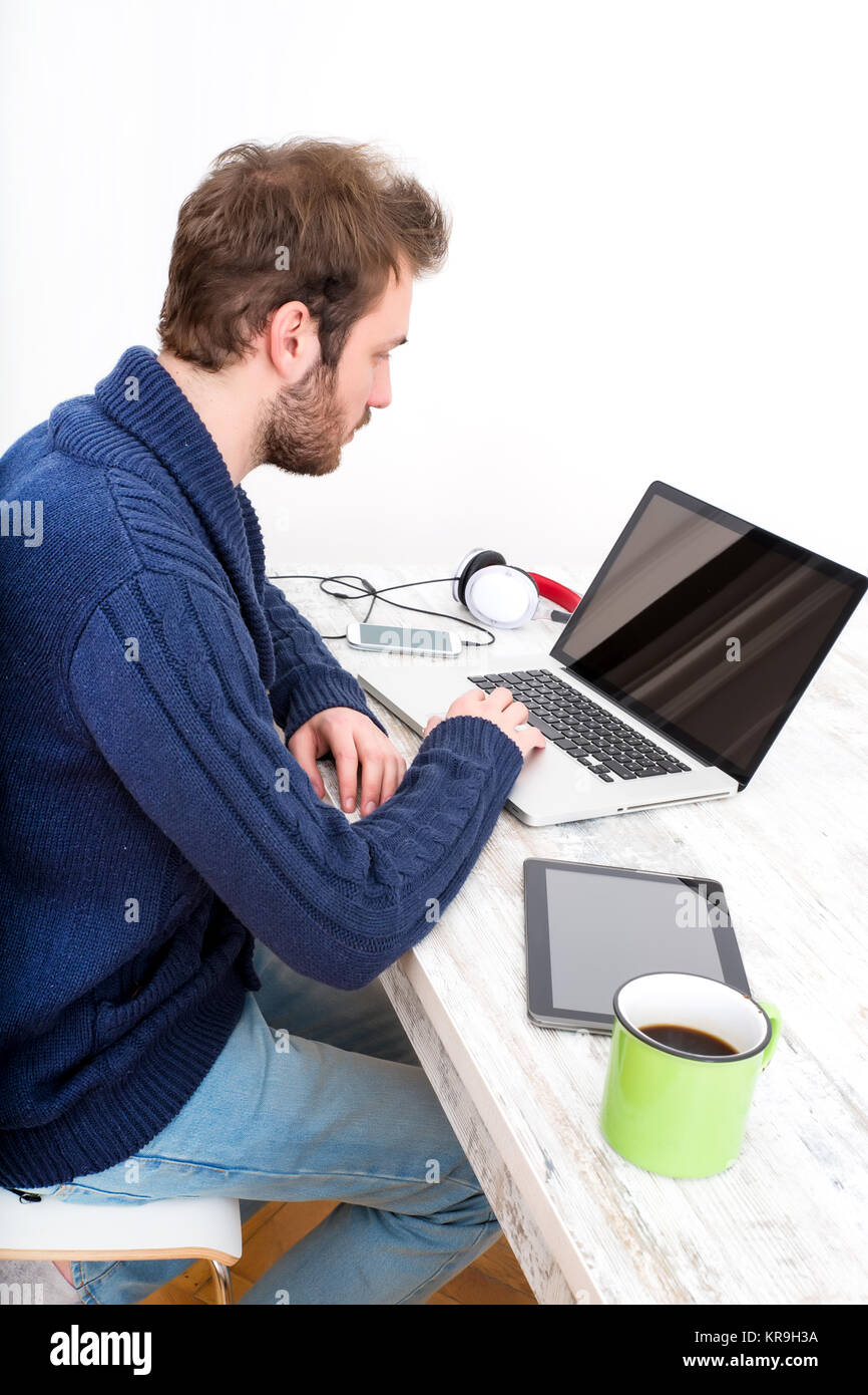 A young man using his laptop computer at home Stock Photo - Alamy