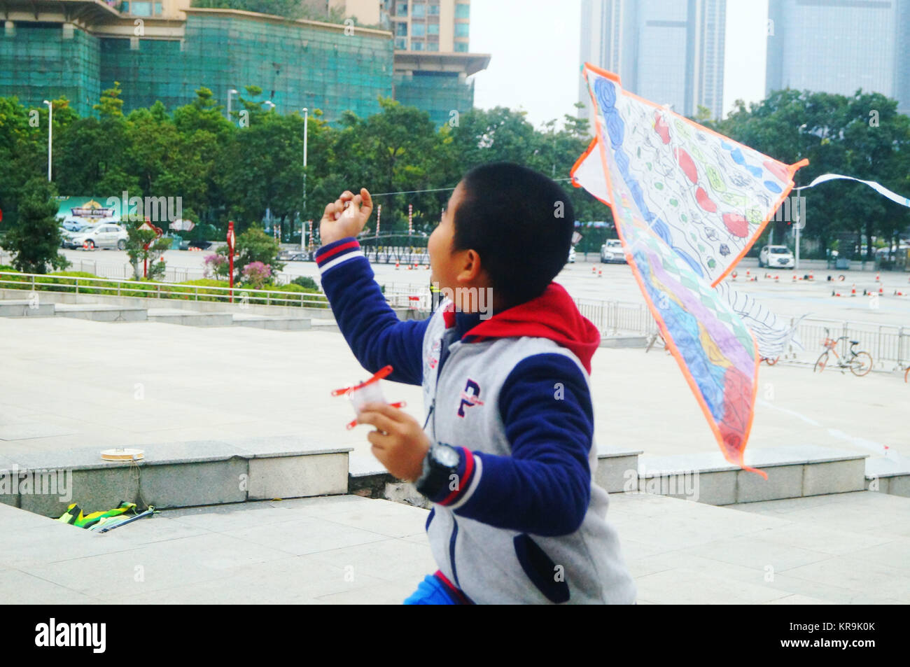 Shenzhen, China: Boys playing kites in the Sports Square Stock Photo ...
