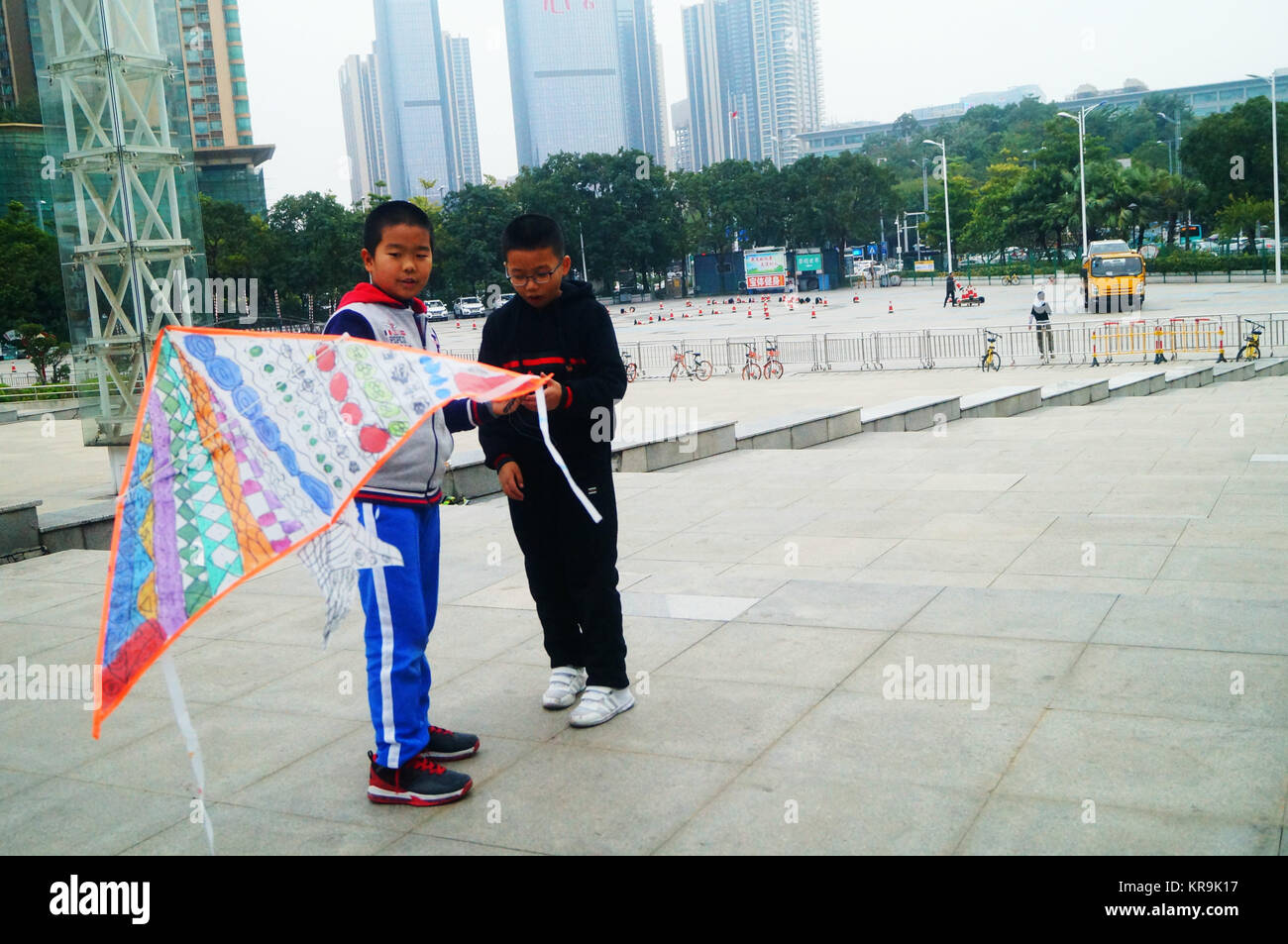 Shenzhen, China: Boys playing kites in the Sports Square Stock Photo ...