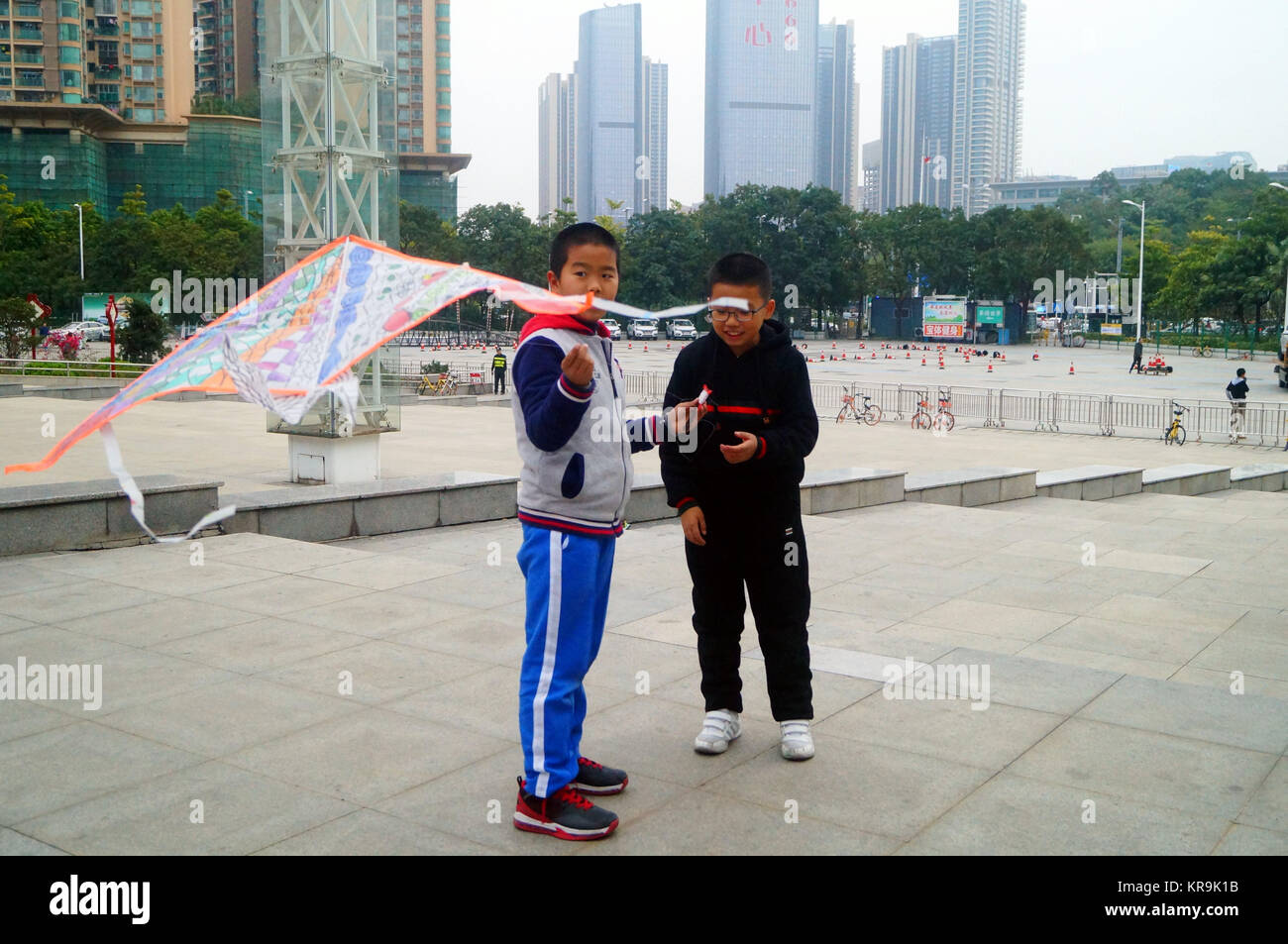 Shenzhen, China: Boys playing kites in the Sports Square Stock Photo ...