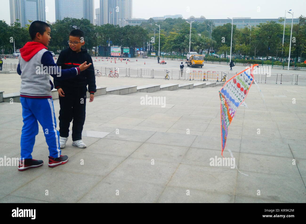 Shenzhen, China: Boys playing kites in the Sports Square Stock Photo ...