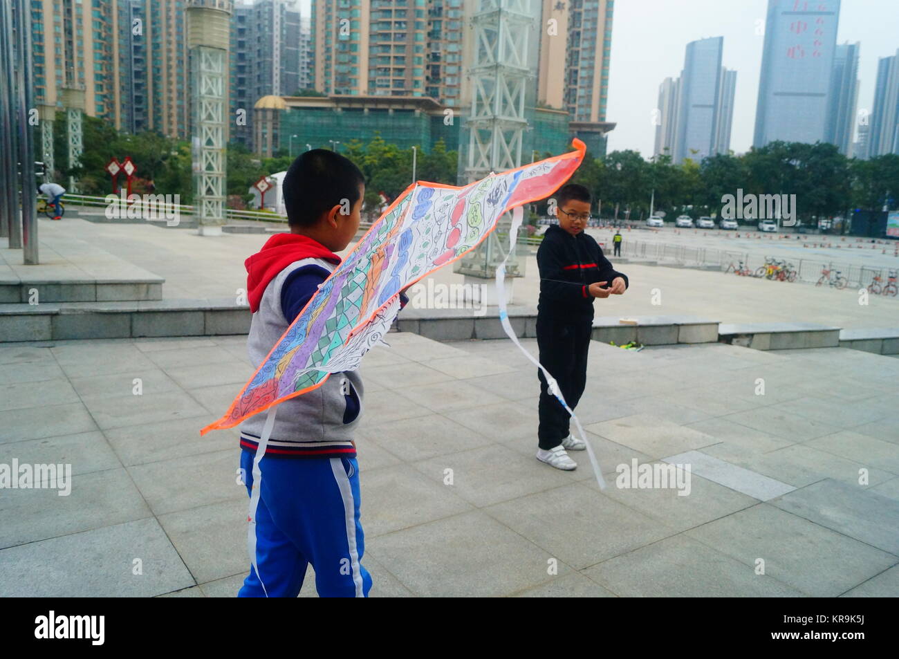 Shenzhen, China: Boys playing kites in the Sports Square Stock Photo ...