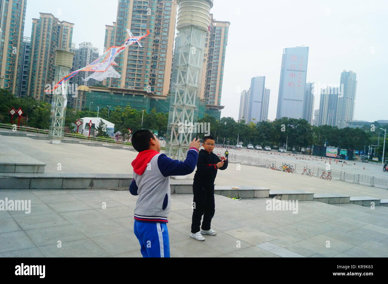 Shenzhen, China: Boys playing kites in the Sports Square Stock Photo ...