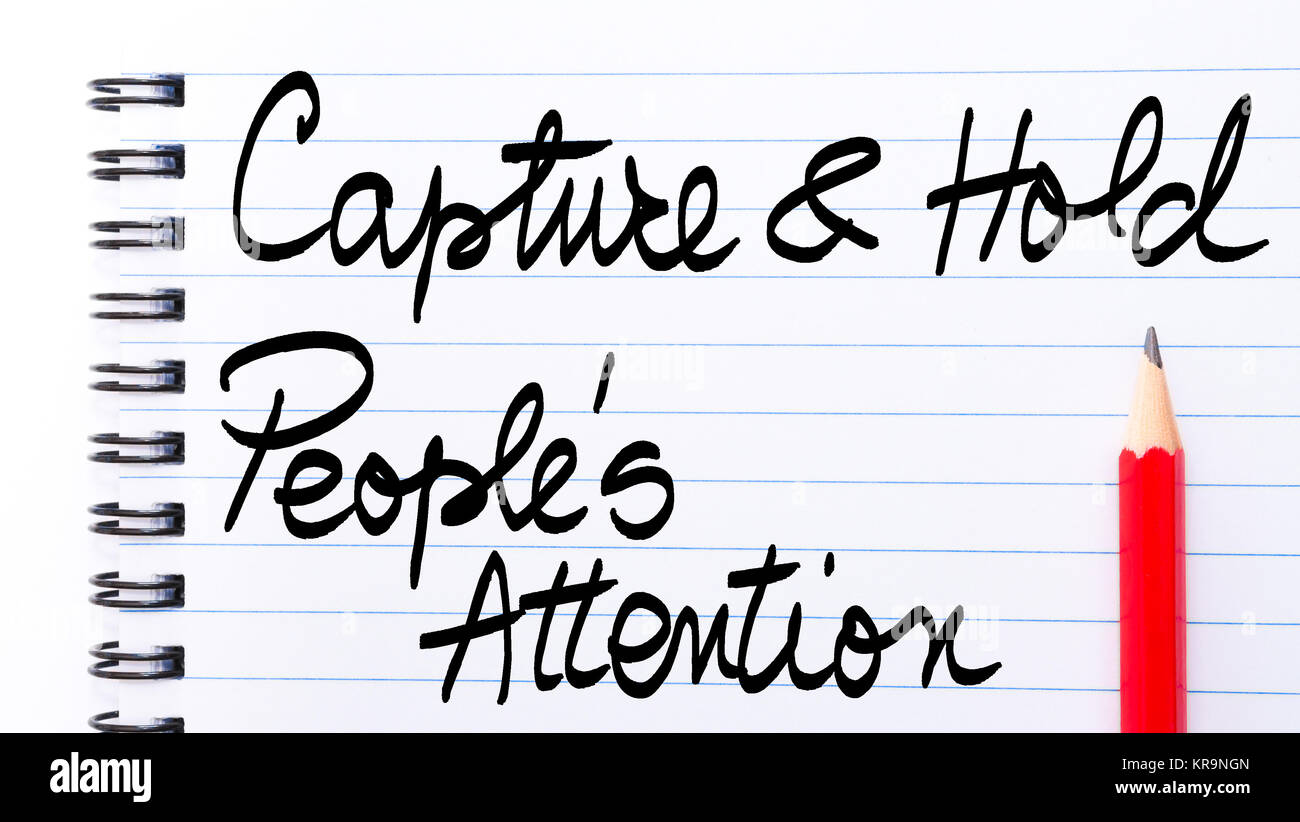 Capture and Hold Peoples Attention Note written on notebook page Stock ...