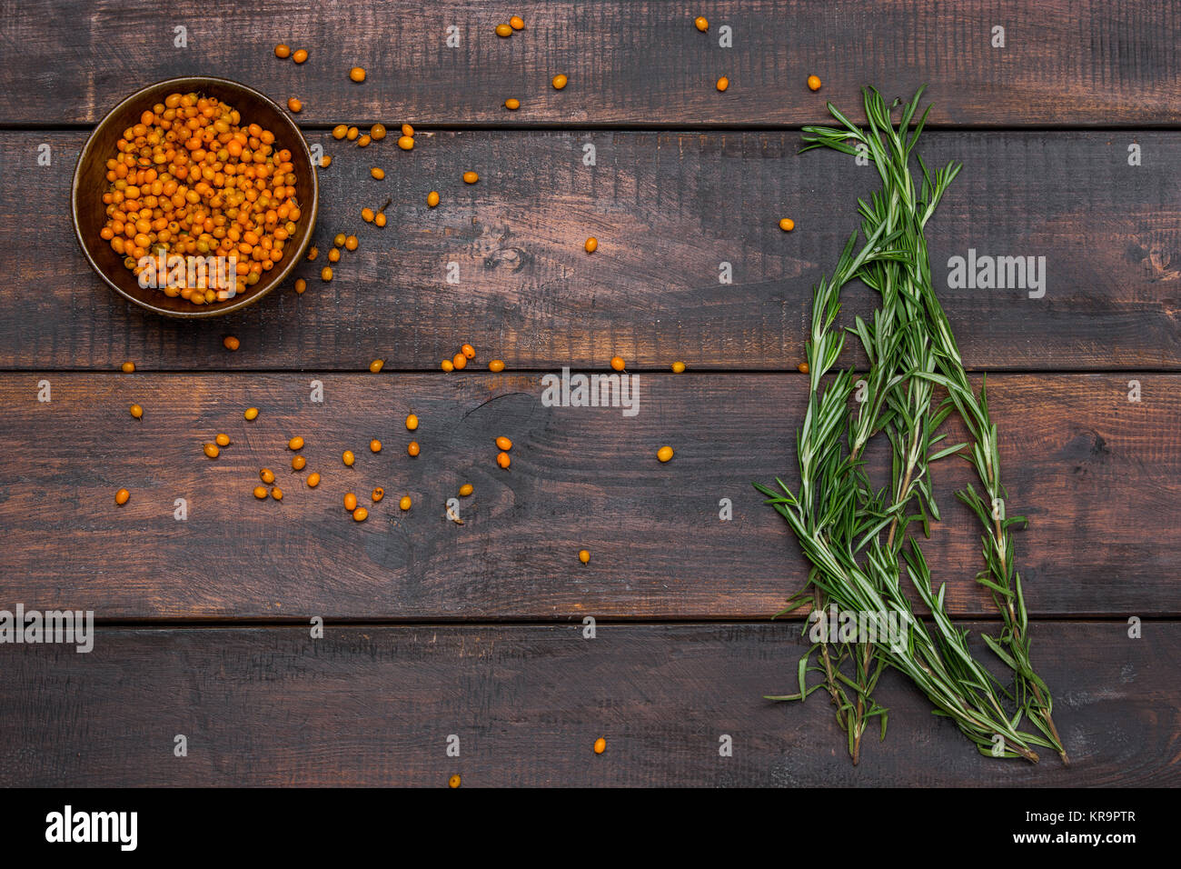 Bunch of rosemary on wooden table, rustic style Stock Photo - Alamy