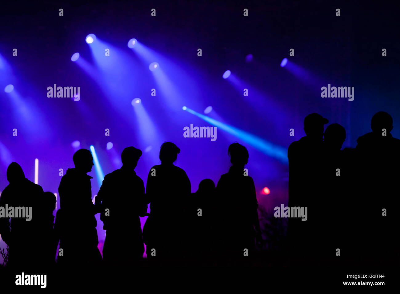 Cheering crowd in front of stage lights Stock Photo - Alamy