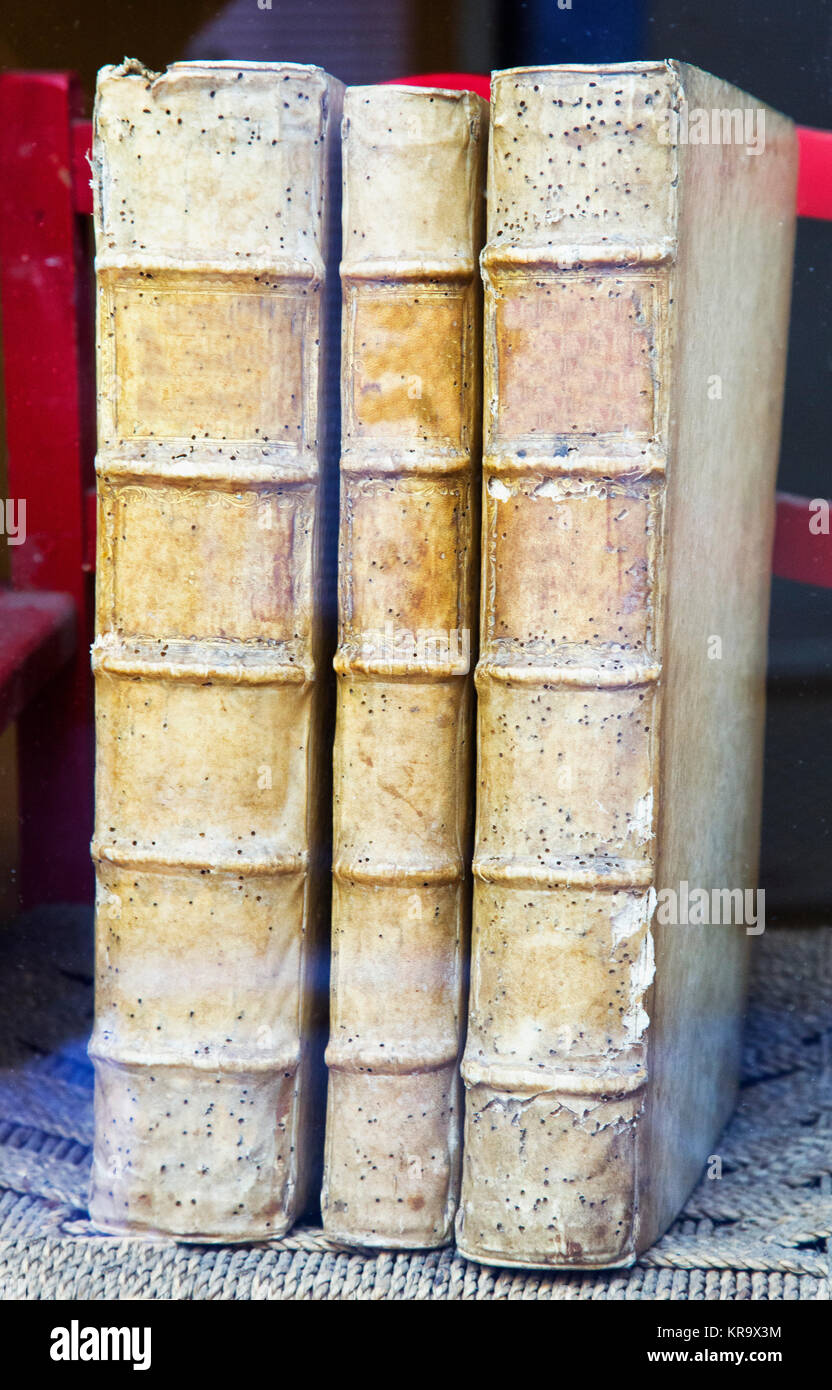 Three very old books standing Stock Photo - Alamy