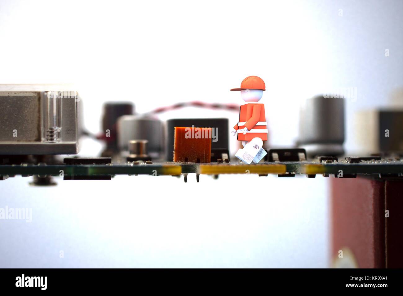 Worker puppet on a computer motherboard Stock Photo - Alamy