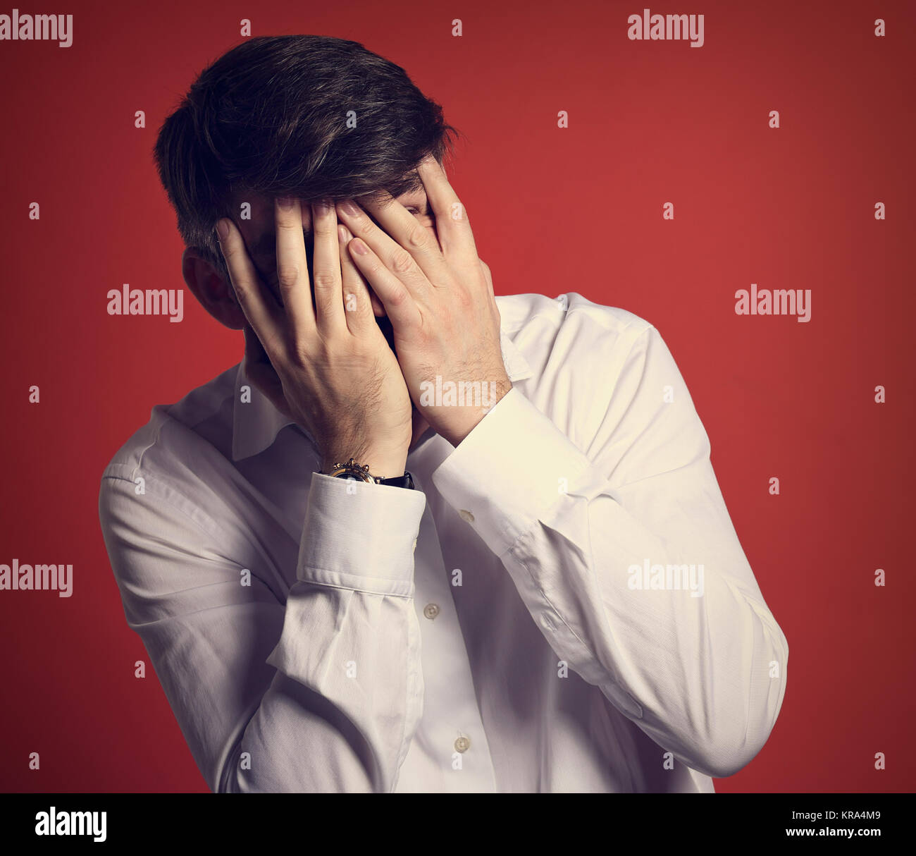 Unhappy scared bearded business man covering and hiding the face his ...