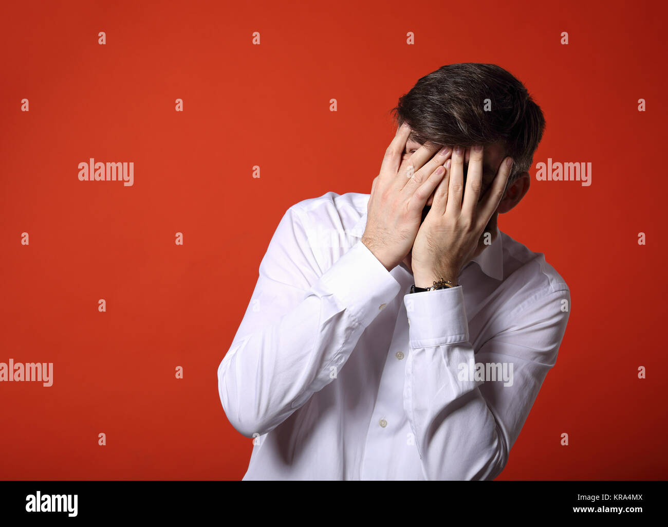 Unhappy scared bearded business man covering and hiding the face his ...
