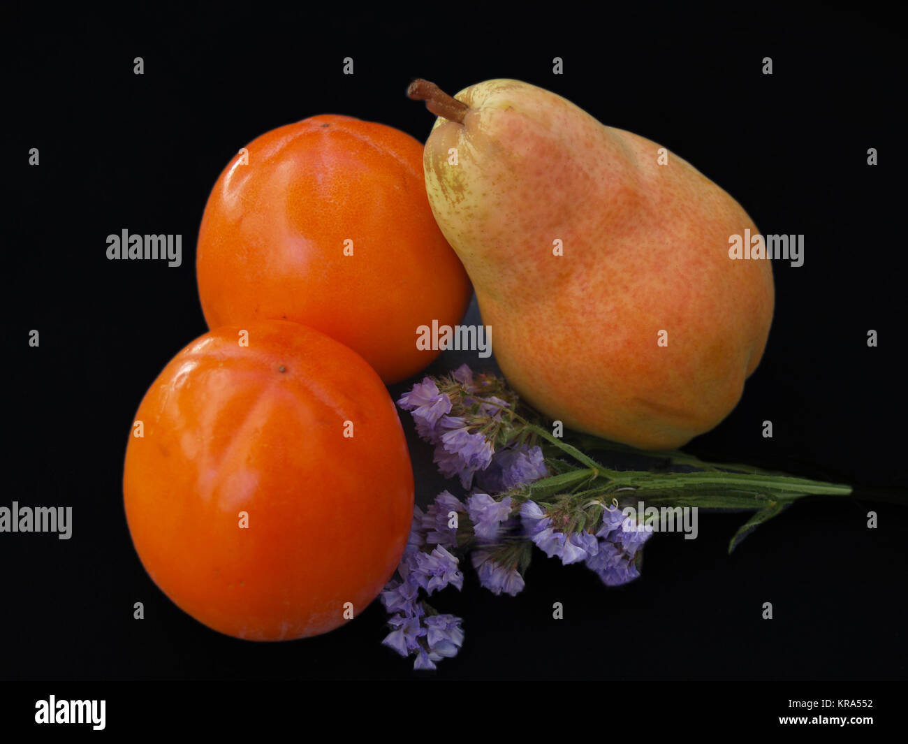 persimmons, pear and dry flowers Stock Photo - Alamy