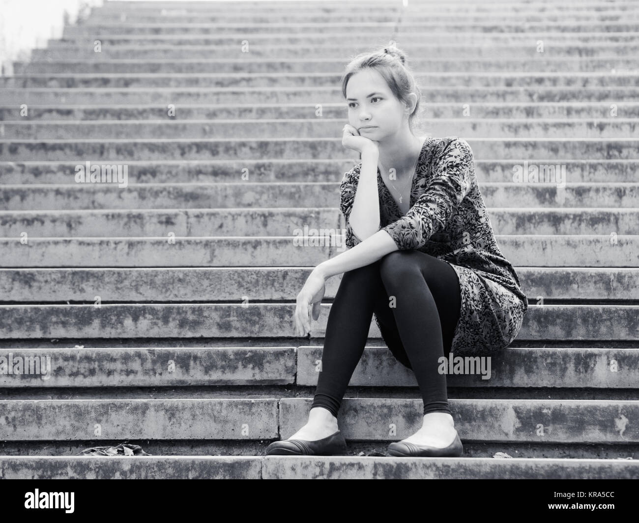 Sad girl sitting on steps Stock Photo - Alamy