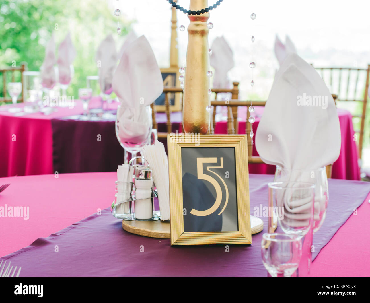 Wedding table with the sign number five Stock Photo - Alamy
