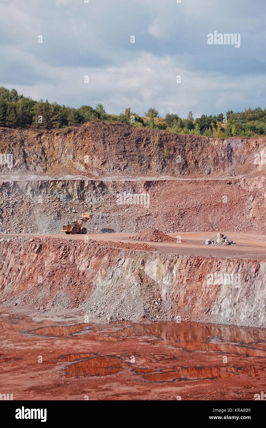 Earthmover in a quarry mine working Stock Photo - Alamy