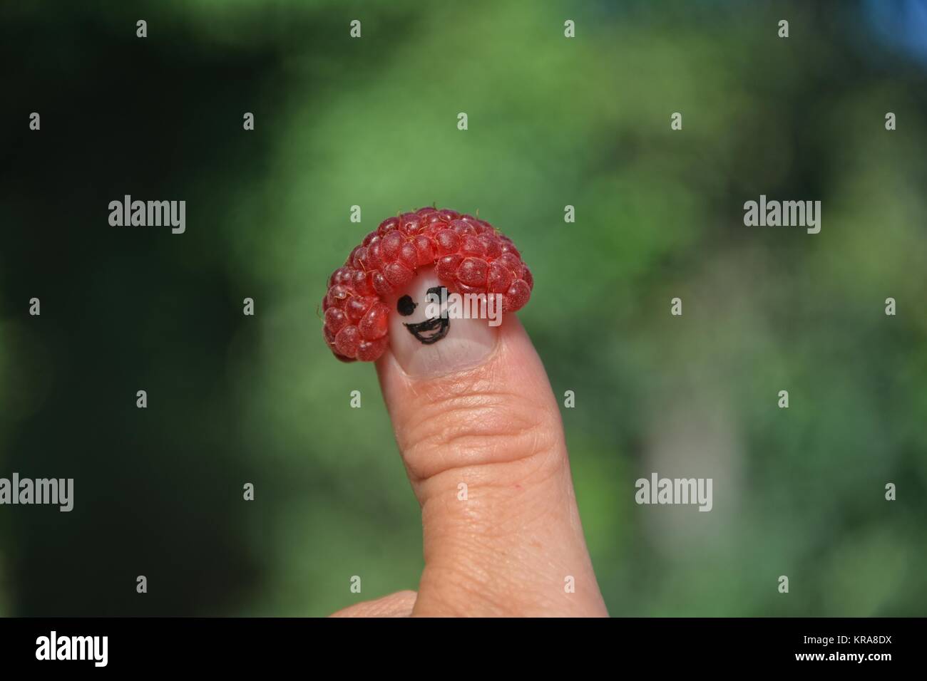 thumbs up with raspberry with a smiling face Stock Photo - Alamy