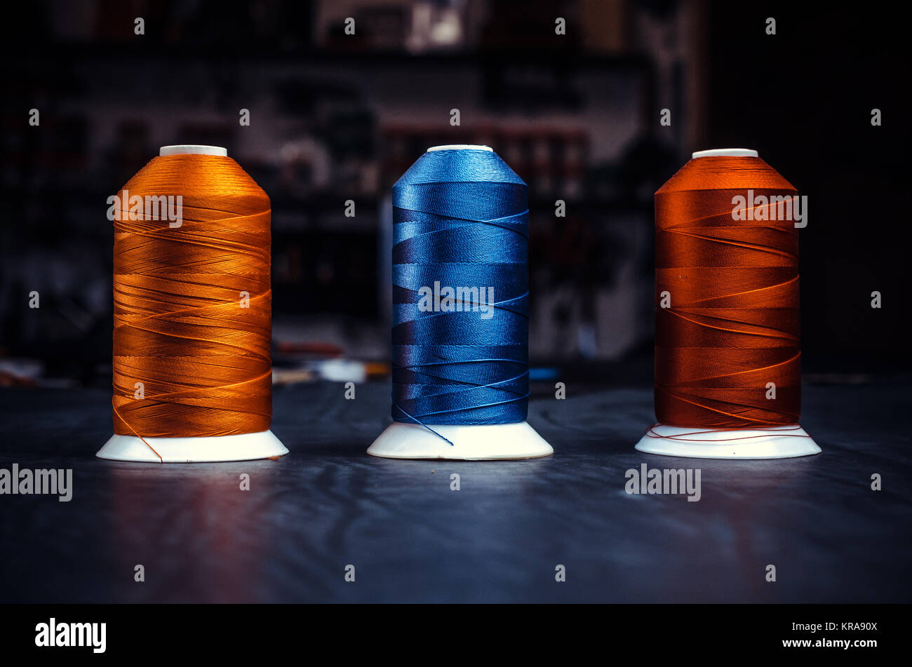 Three bright reel of silk thread on a black background in line Stock ...