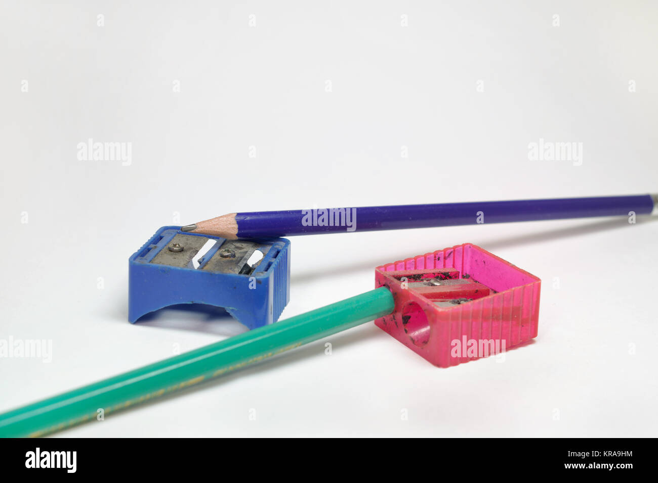 pencil sharpeners and two pencils: green and blue Stock Photo - Alamy