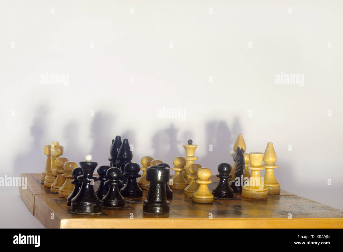 old checkerboard and the party in full swing. Chess pieces cast a ...