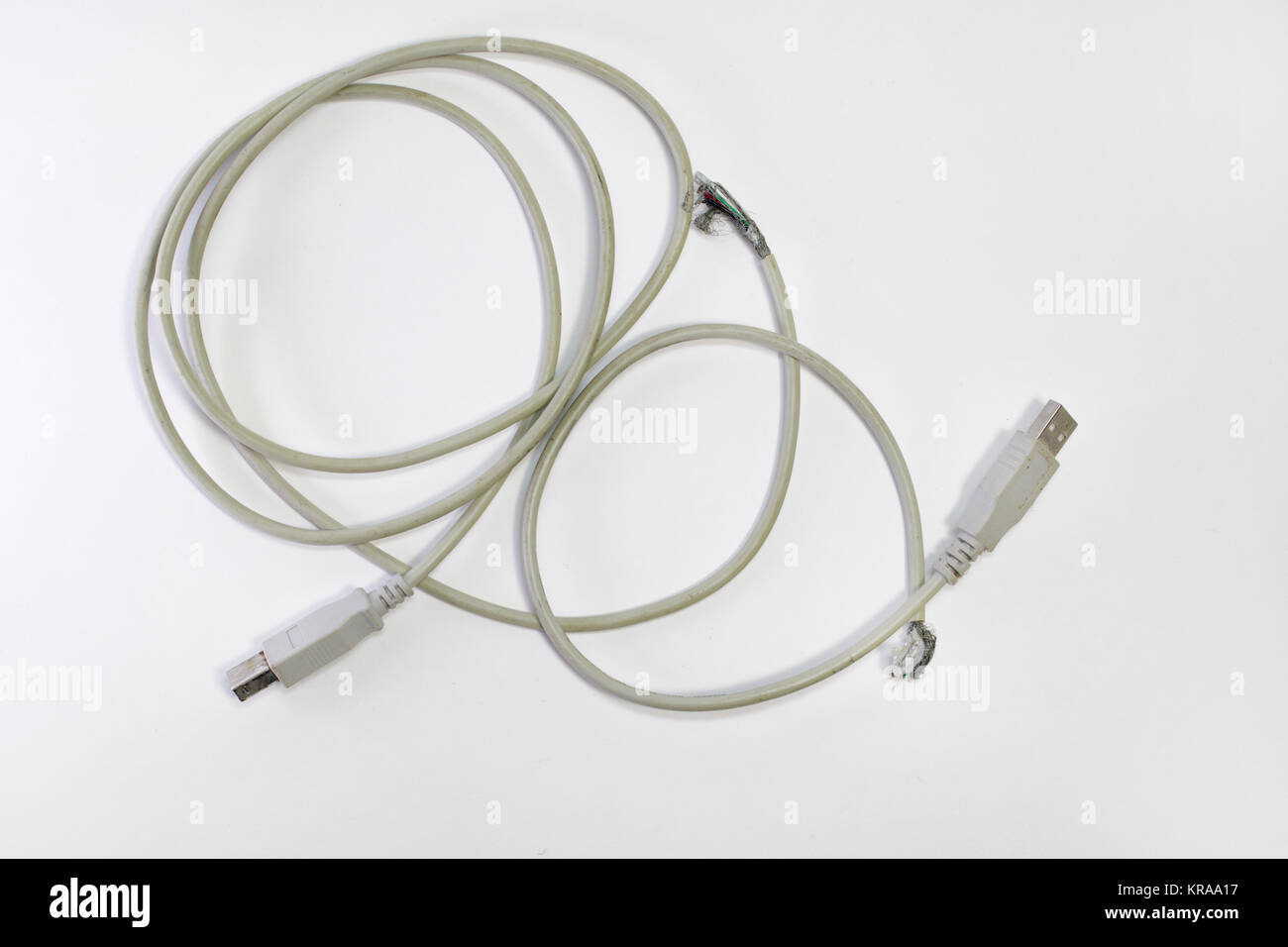 Ragged usb wire. USB-plugs. On white background Stock Photo - Alamy