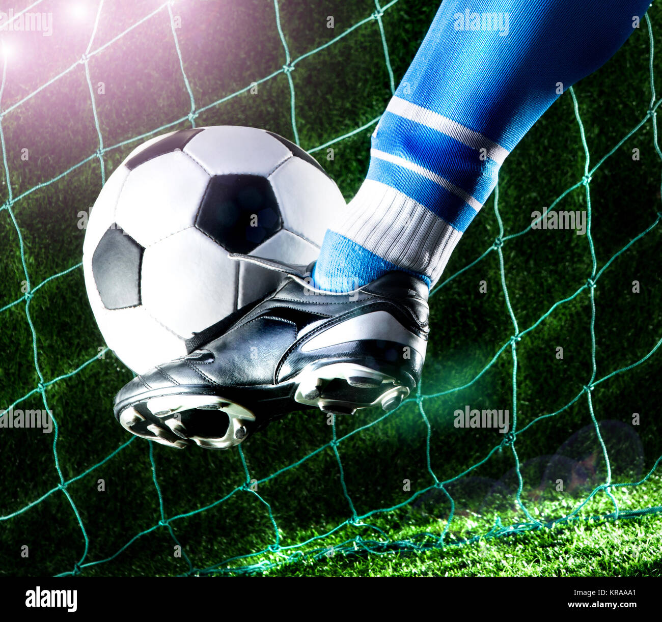 Foot kicking soccer ball Stock Photo - Alamy