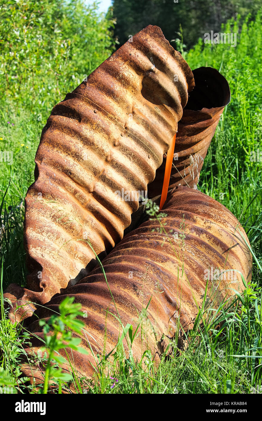 A rusty twisted culvert in the grass Stock Photo - Alamy