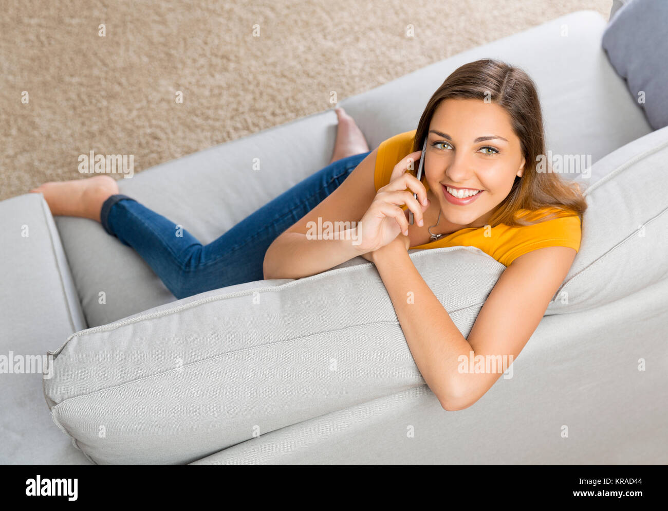 Happy woman texting Stock Photo - Alamy