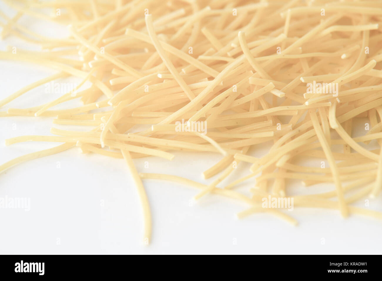 Small dry pasta noodles on white background Stock Photo - Alamy