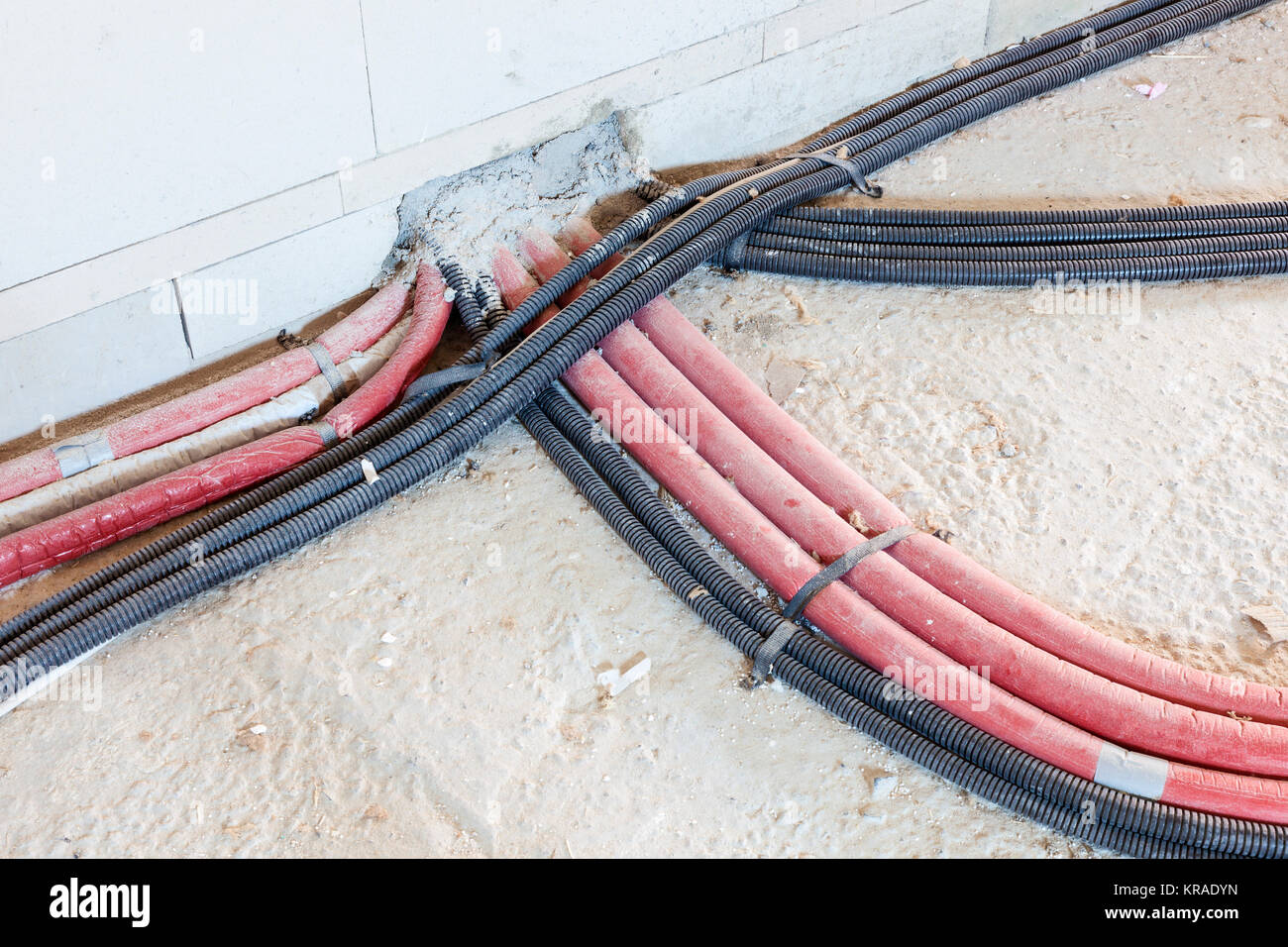 Installation of cables and pipes on the floor of a new house Stock ...