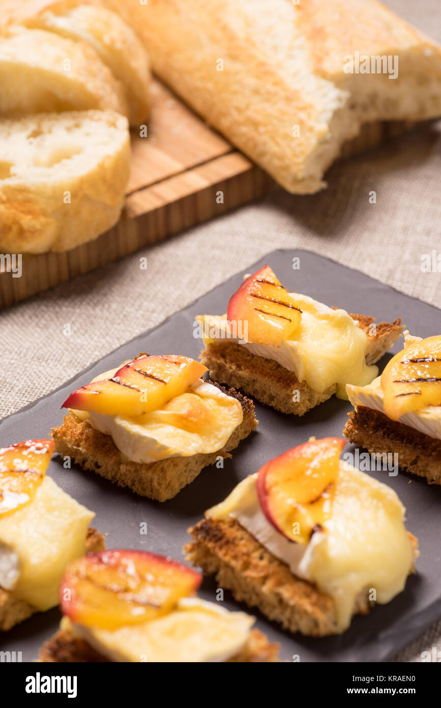 canapes, appetizer with grilled brie Stock Photo - Alamy