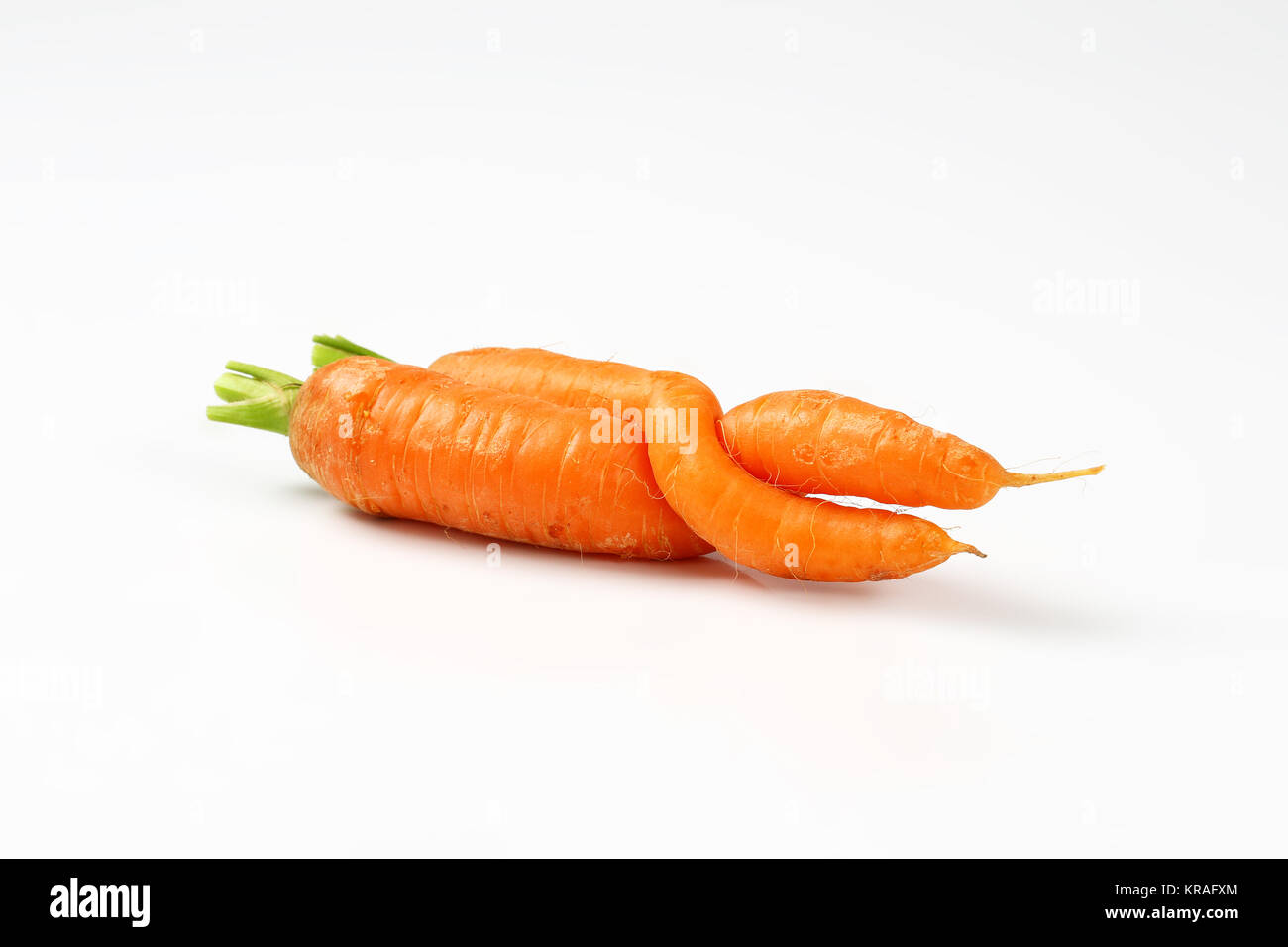 two twisted carrots Stock Photo - Alamy