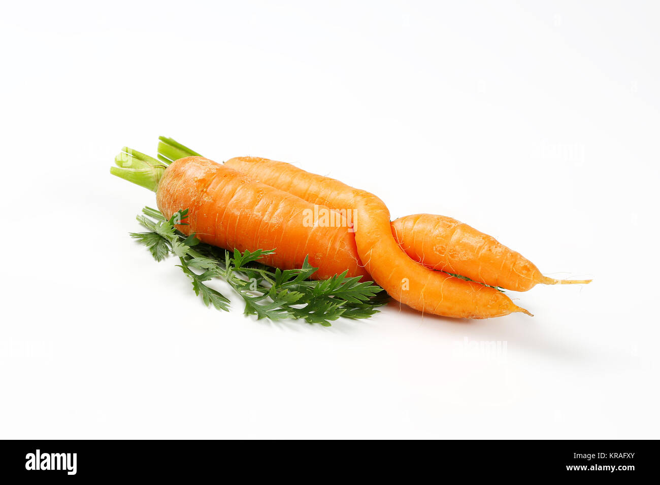 two twisted carrots Stock Photo - Alamy
