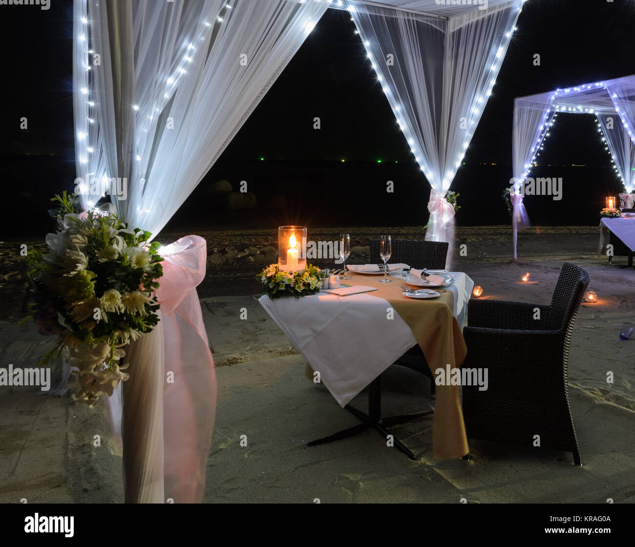 Romantic dinner setup on beach at night Stock Photo - Alamy